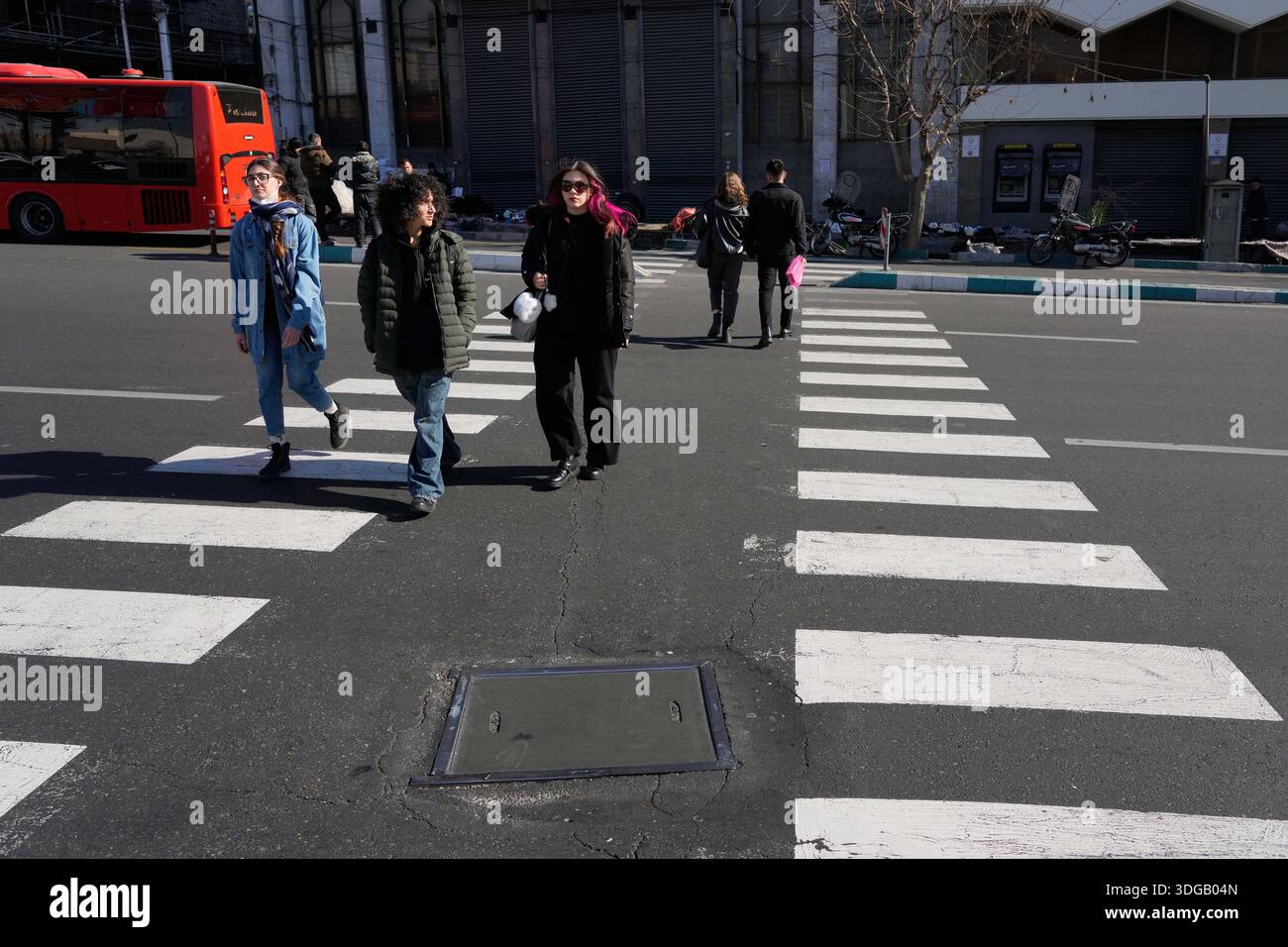 People cross an intersection in downtown Tehran, Iran, Friday, Jan. 16 ...