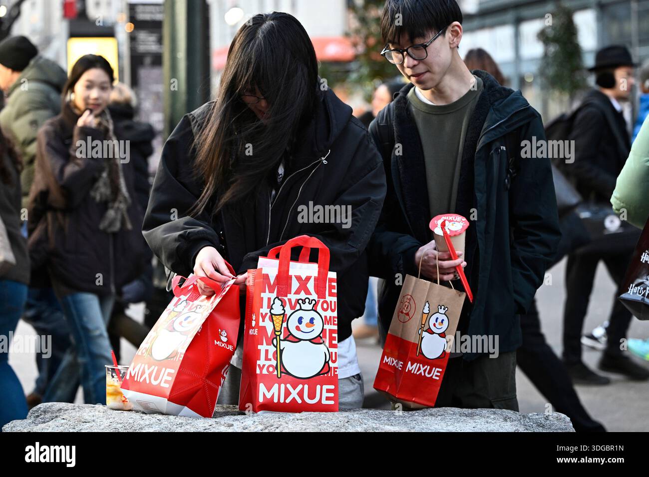 New York, USA. 15th Jan, 2026. Customers look through their Mixue ...