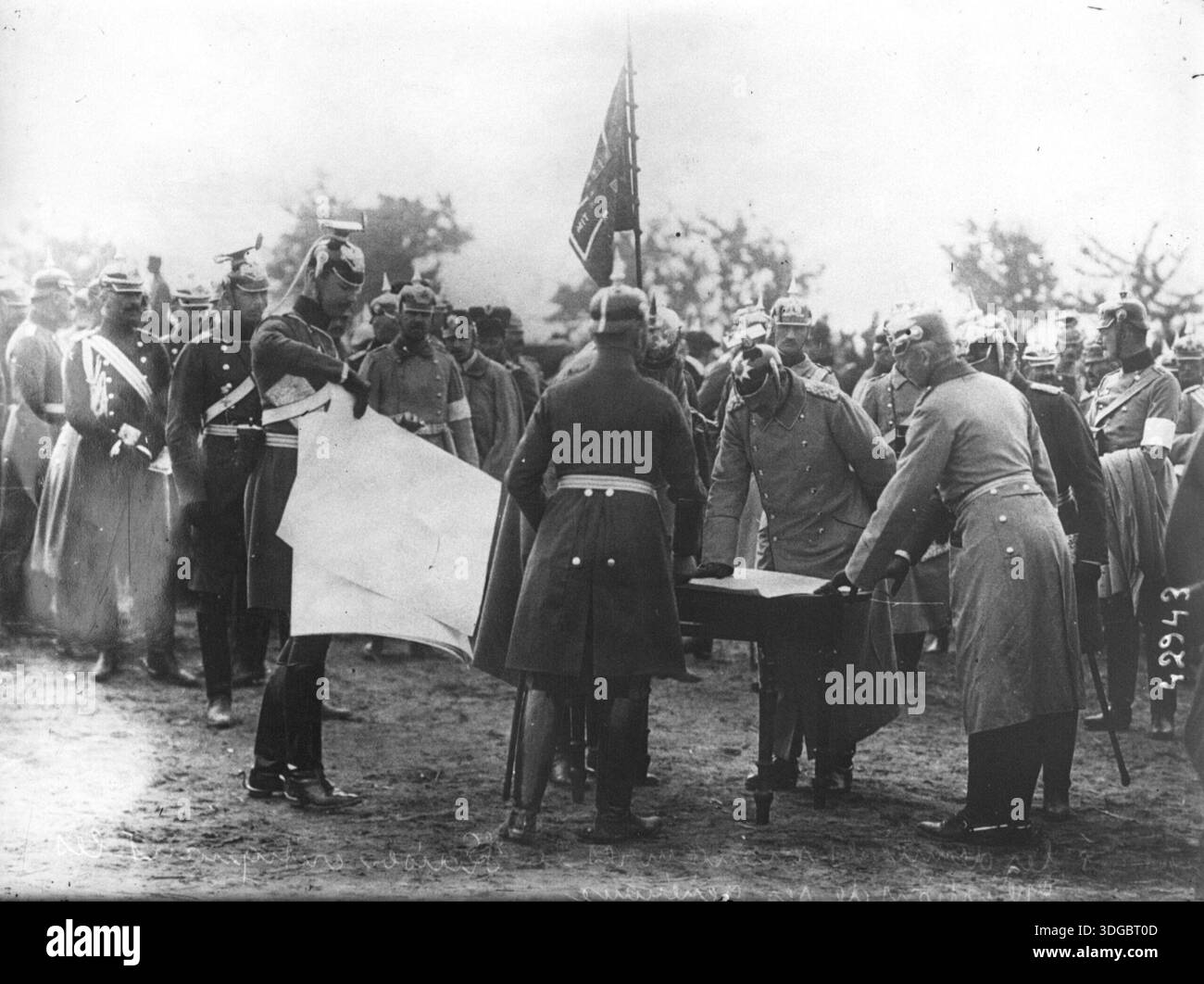Kaiser Wilhelm II (center) examines maps on a field table while ...