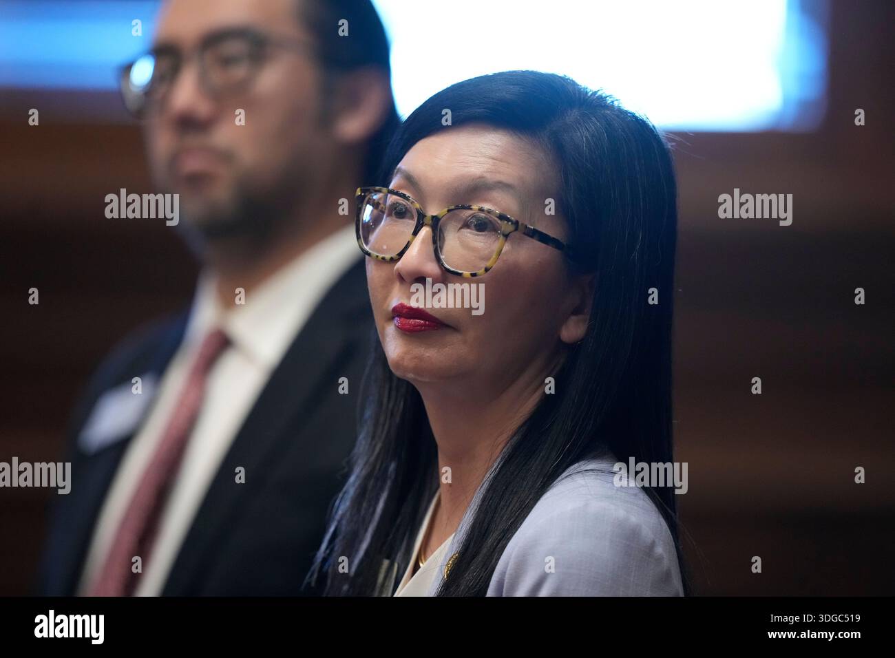 state Rep. Michelle Au, a Democrat from Johns Creek, listens to Gov ...
