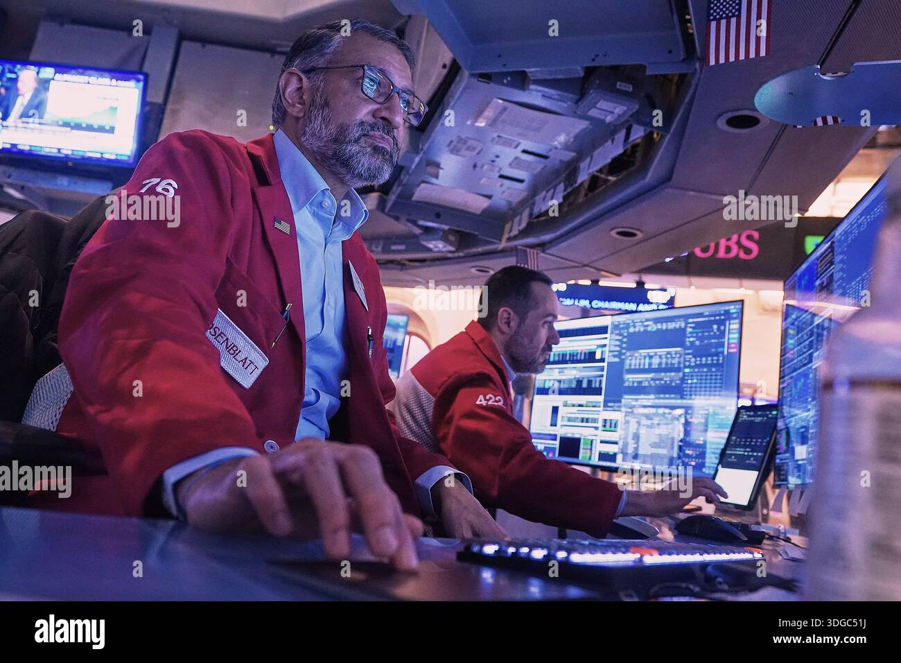 Traders Anan Patel, left, and Robert Greason work on the floor of the ...