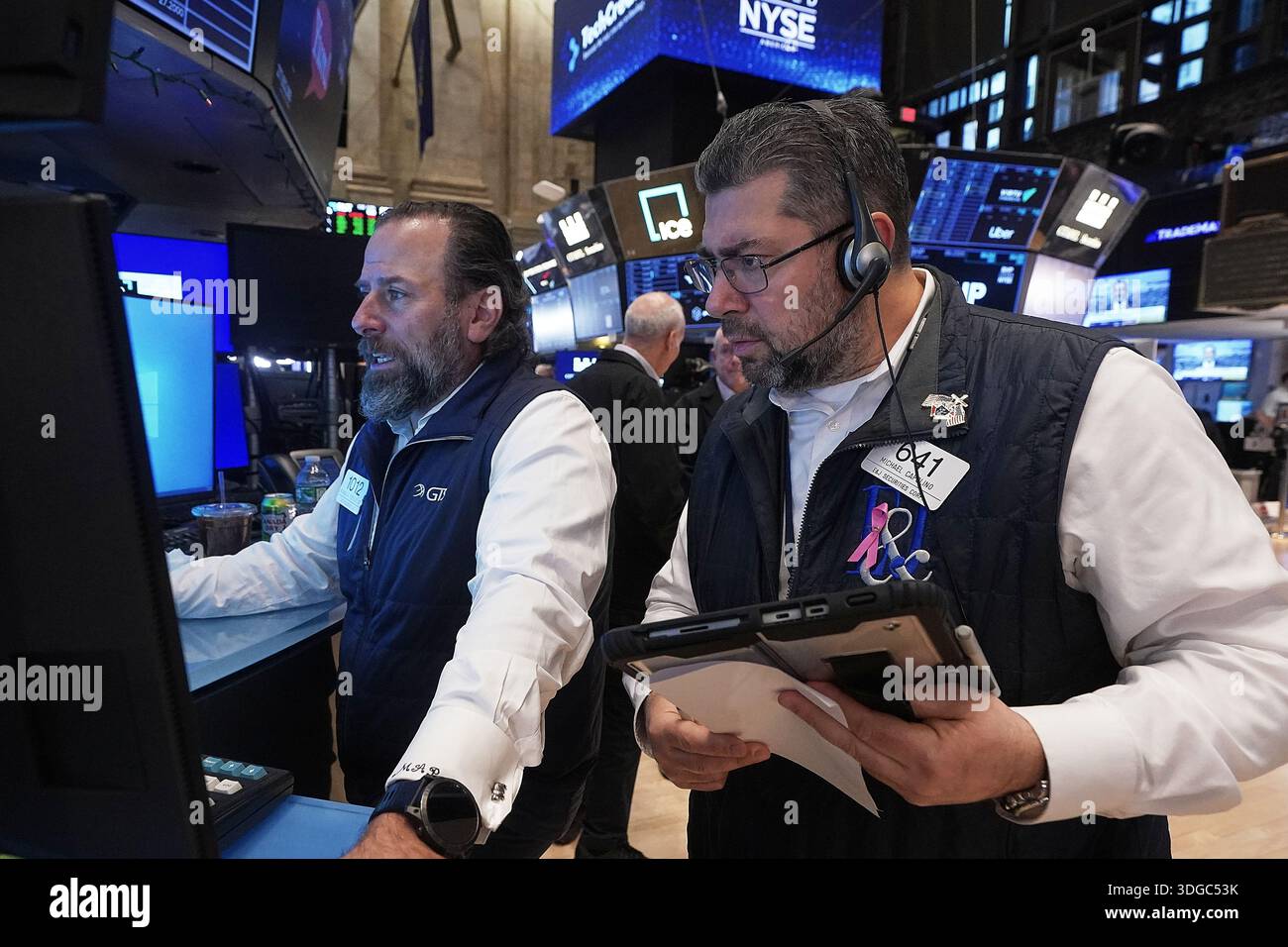 Specialist Michael Pistillo, left, and trader Michael Capolino work on ...