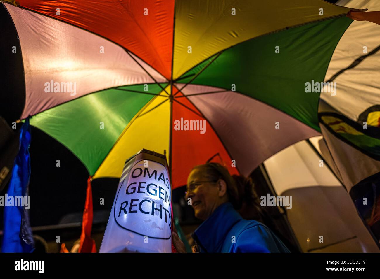 Cottbus, Germany. 16th Jan, 2026. A woman carries a lamp with the ...