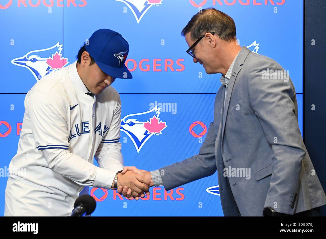 Kazuma Okamoto, left, shakes hands with Toronto Blue Jays general ...