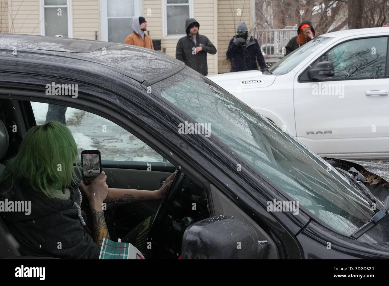 People film Federal Enforcement officers on Friday, Jan. 16, 2026, in ...