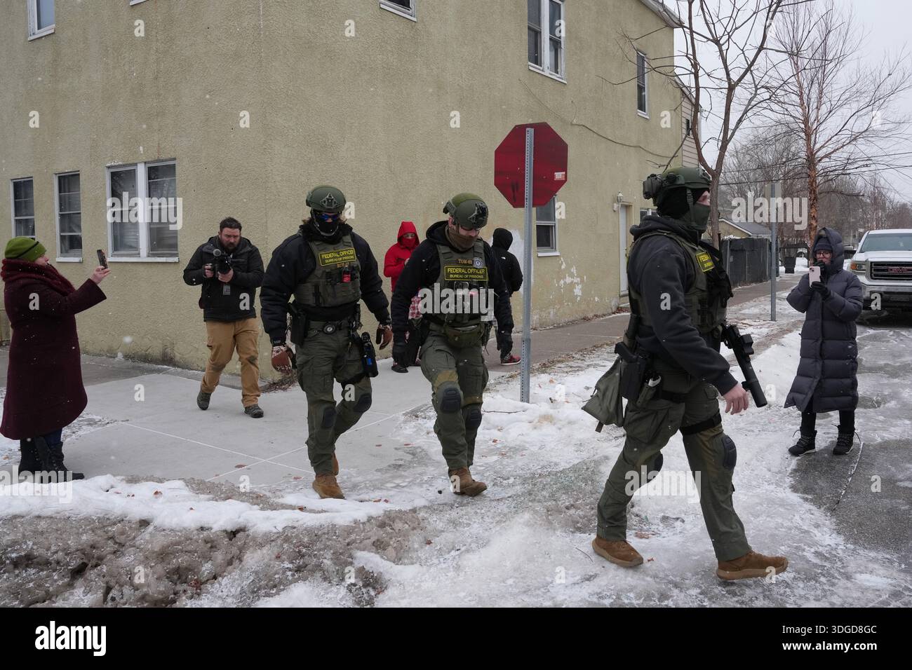 People film Federal Enforcement officers on Friday, Jan. 16, 2026, in ...