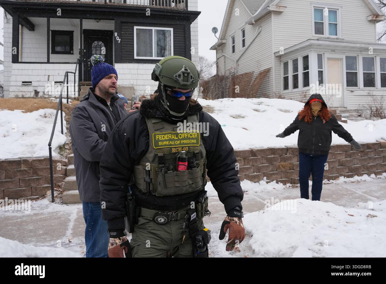 People film Federal Enforcement officers on Friday, Jan. 16, 2026, in ...