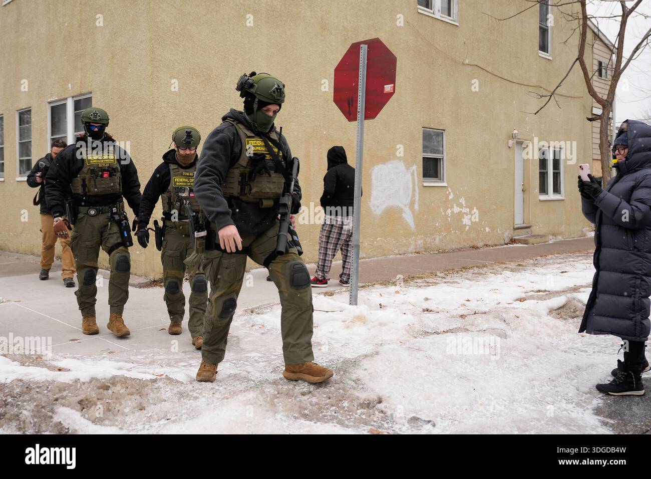 People film Federal Enforcement officers on Friday, Jan. 16, 2026, in ...