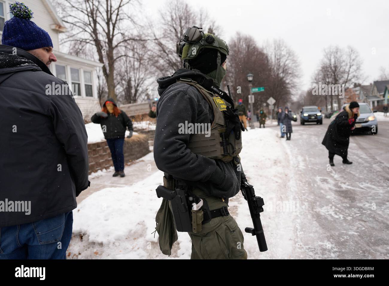 People confront Federal Enforcement officers on Friday, Jan. 16, 2026 ...