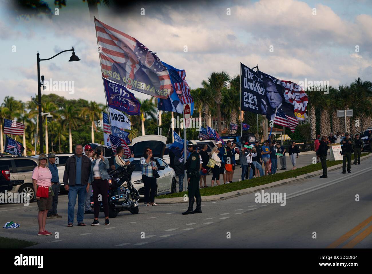 Supporters wave flags as President Donald Trump motorcades through West ...