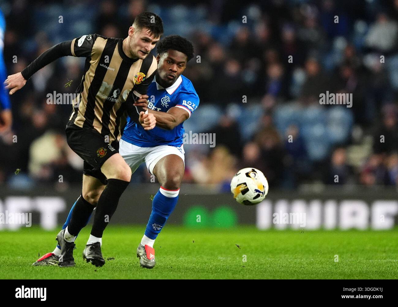 Annan Athletic's Tommy Muir (left) and Rangers' Tochi Chukwuani battle ...