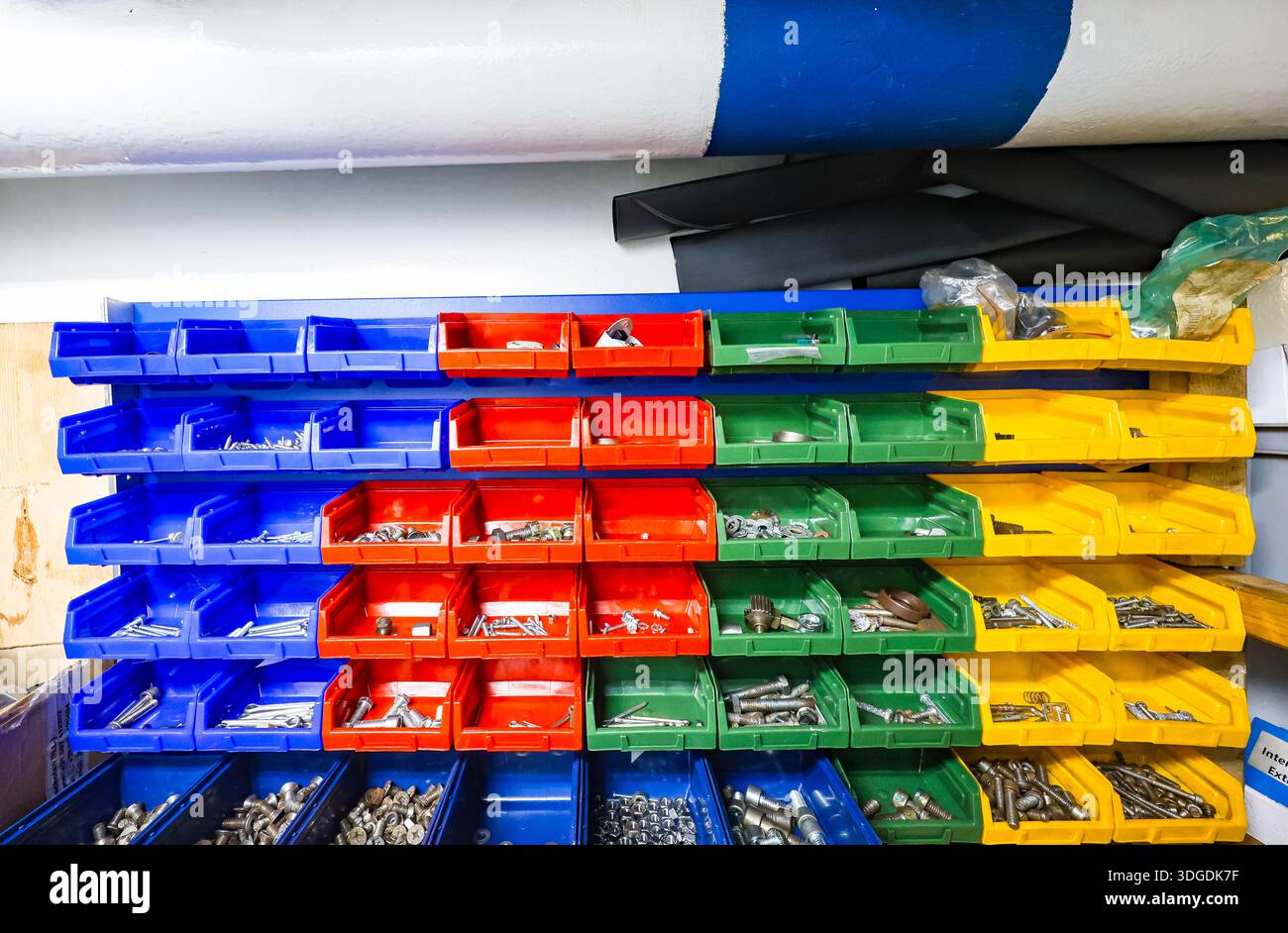 Colorful plastic storage bins with bolts, screws and metal fasteners ...