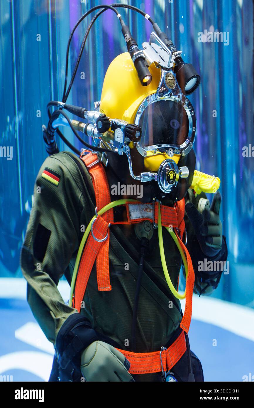 A diver wearing historic helmet diving equipment takes part in a ...