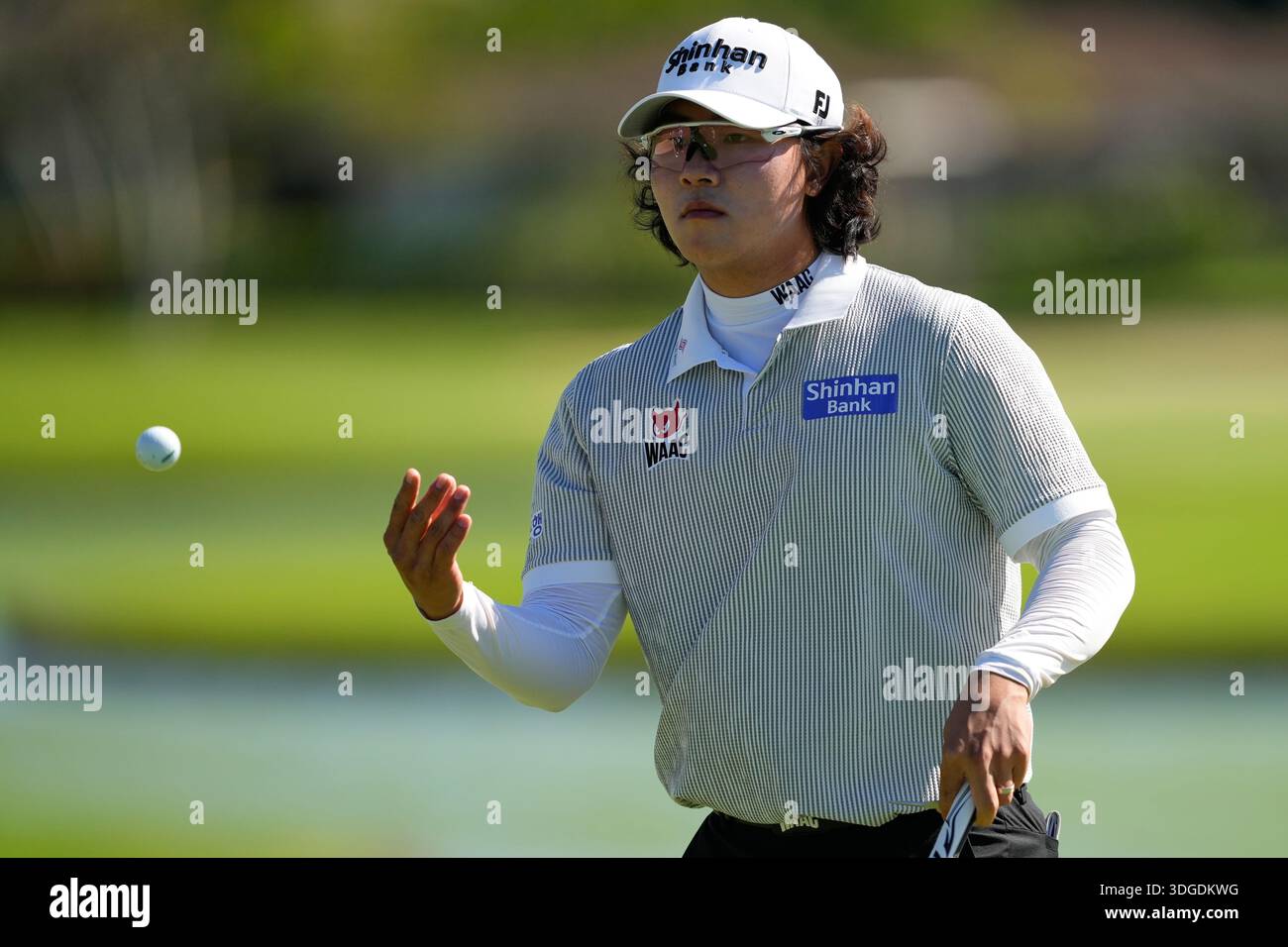 S.H. Kim, of South Korea, catches a ball on the third hole during the ...