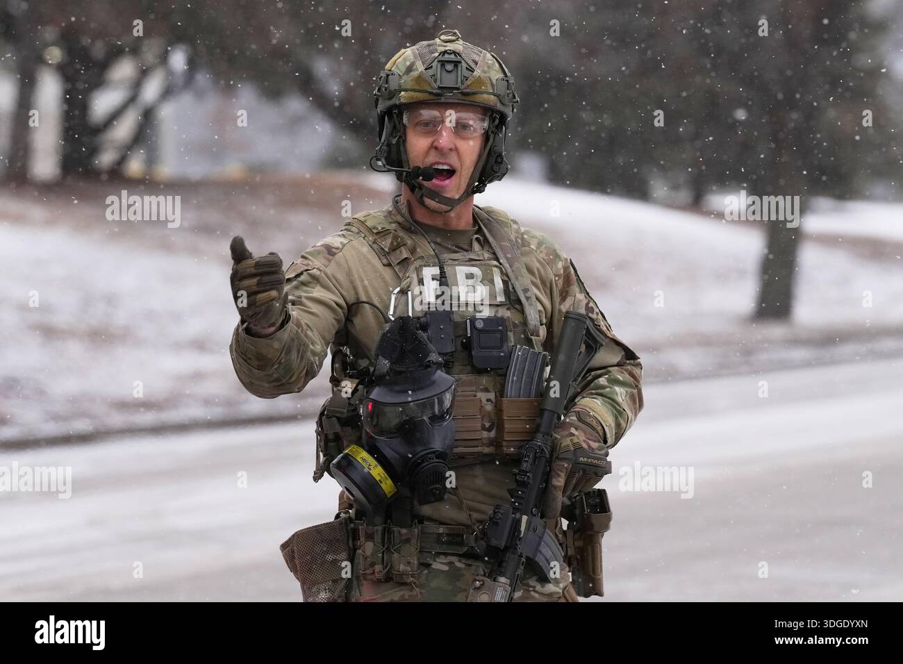 An FBI officer works a scene during operations on Friday, Jan. 16, 2026 ...