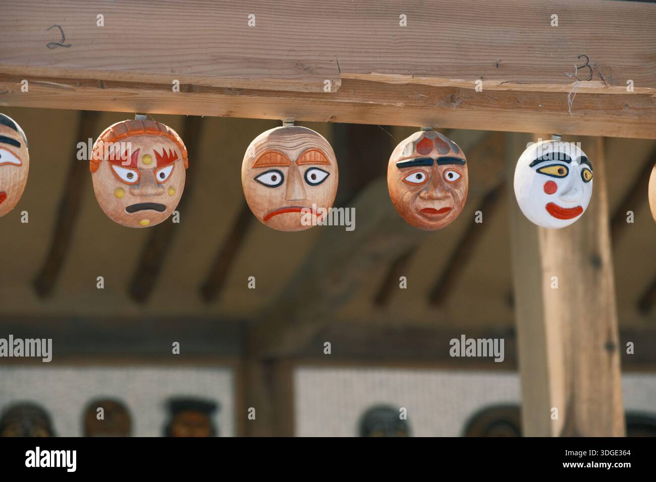 Yongin, South Korea: Traditional Korean tal masks hanging under hanok ...