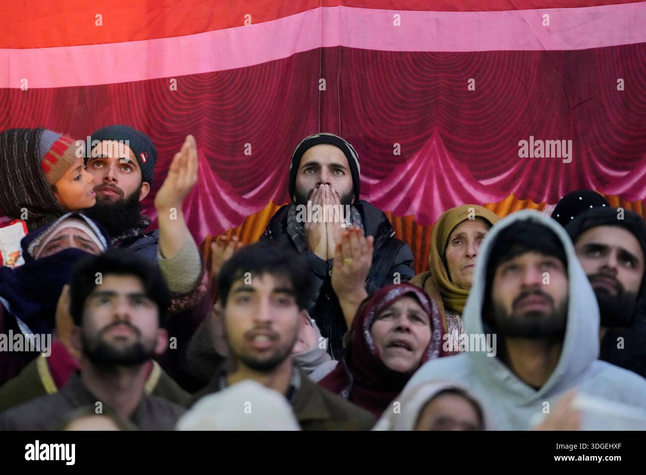 Kashmiri Muslim devotees pray as a head priest displays a relic ...