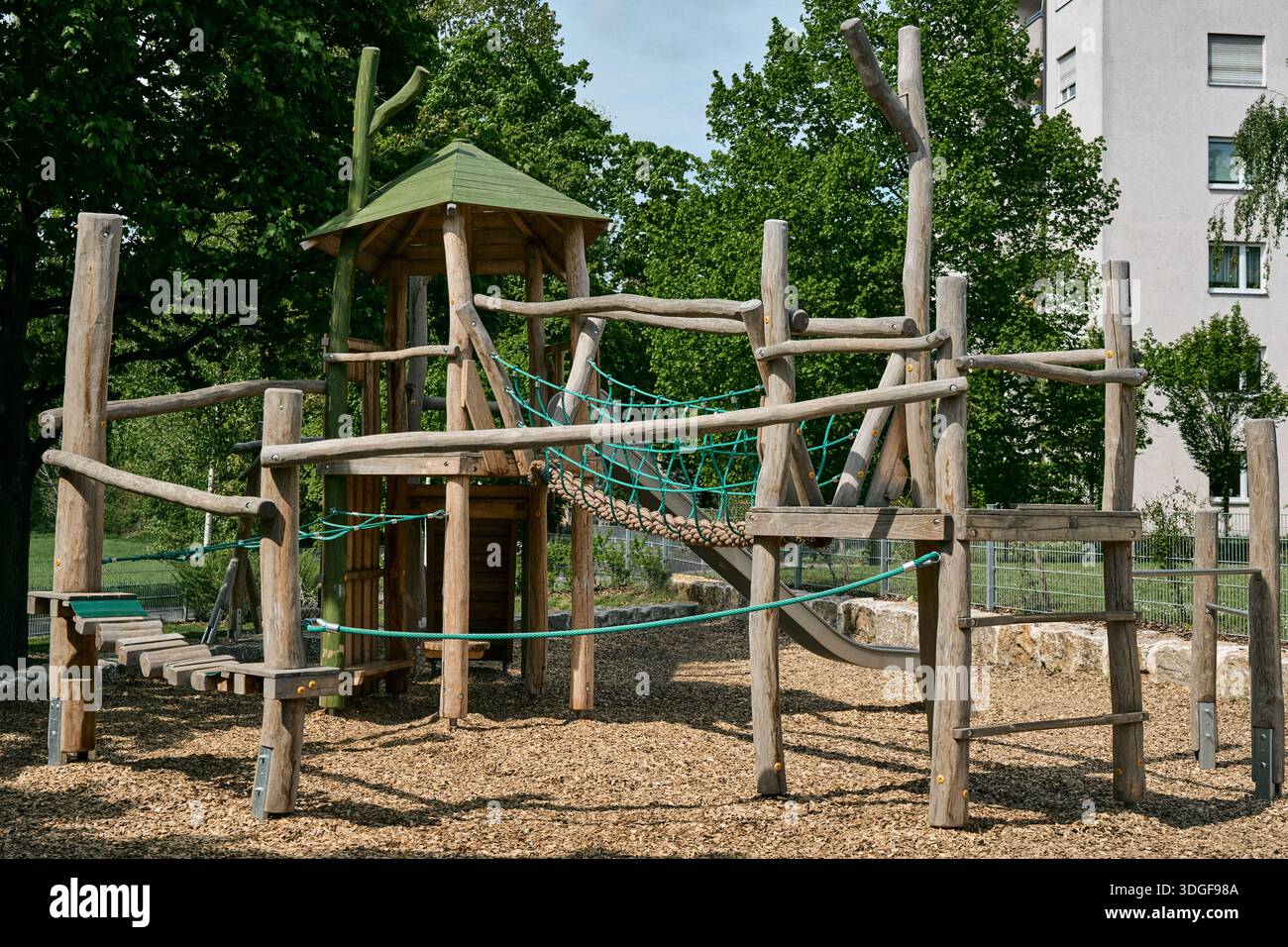 Wooden playground with climbing frames, rope nets and platforms in a ...