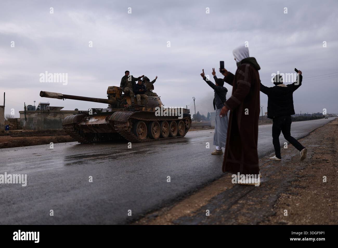 People welcome Syrian government forces as they enter the town of Deir ...