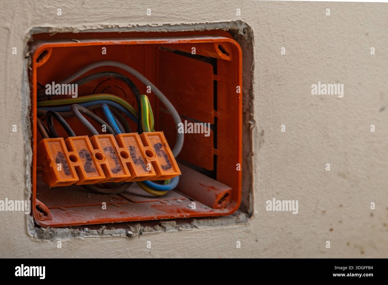 Electrical box mounted in a hole drilled in the wall, three-phase ...