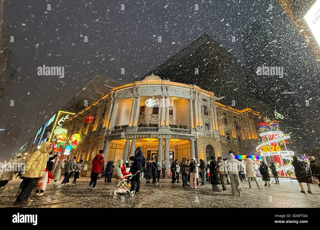 Tianjin, China. 17th Jan, 2026. People walk amid snowfall on a street ...