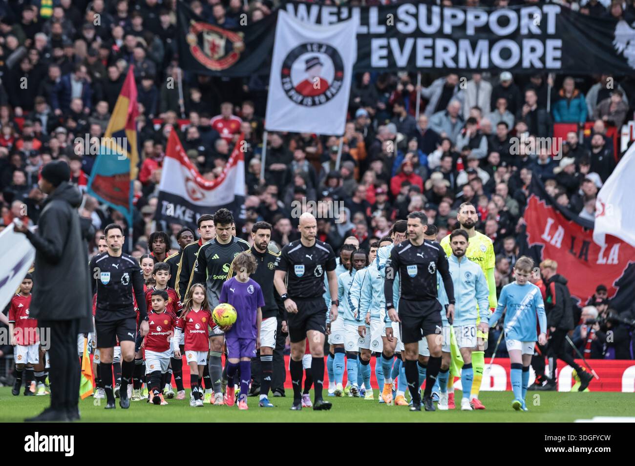 Referee Anthony Taylor leads both teams out during the Premier League ...
