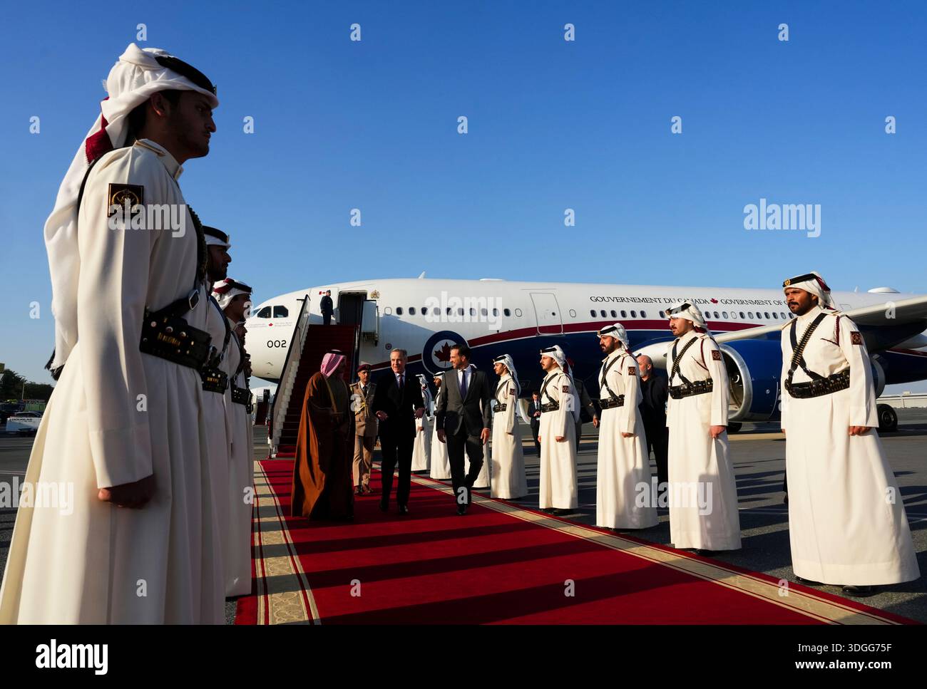Doha, Qatar. 17th Jan, 2026. Prime Minister Mark Carney, middle, walks ...