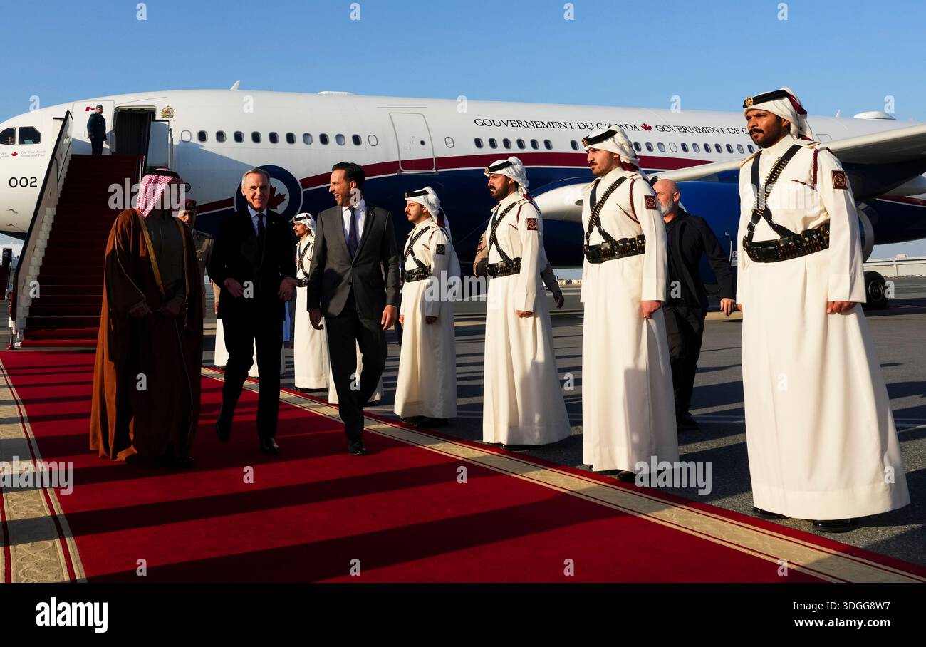 Doha, Qatar. 17th Jan, 2026. Prime Minister Mark Carney, middle, walks ...