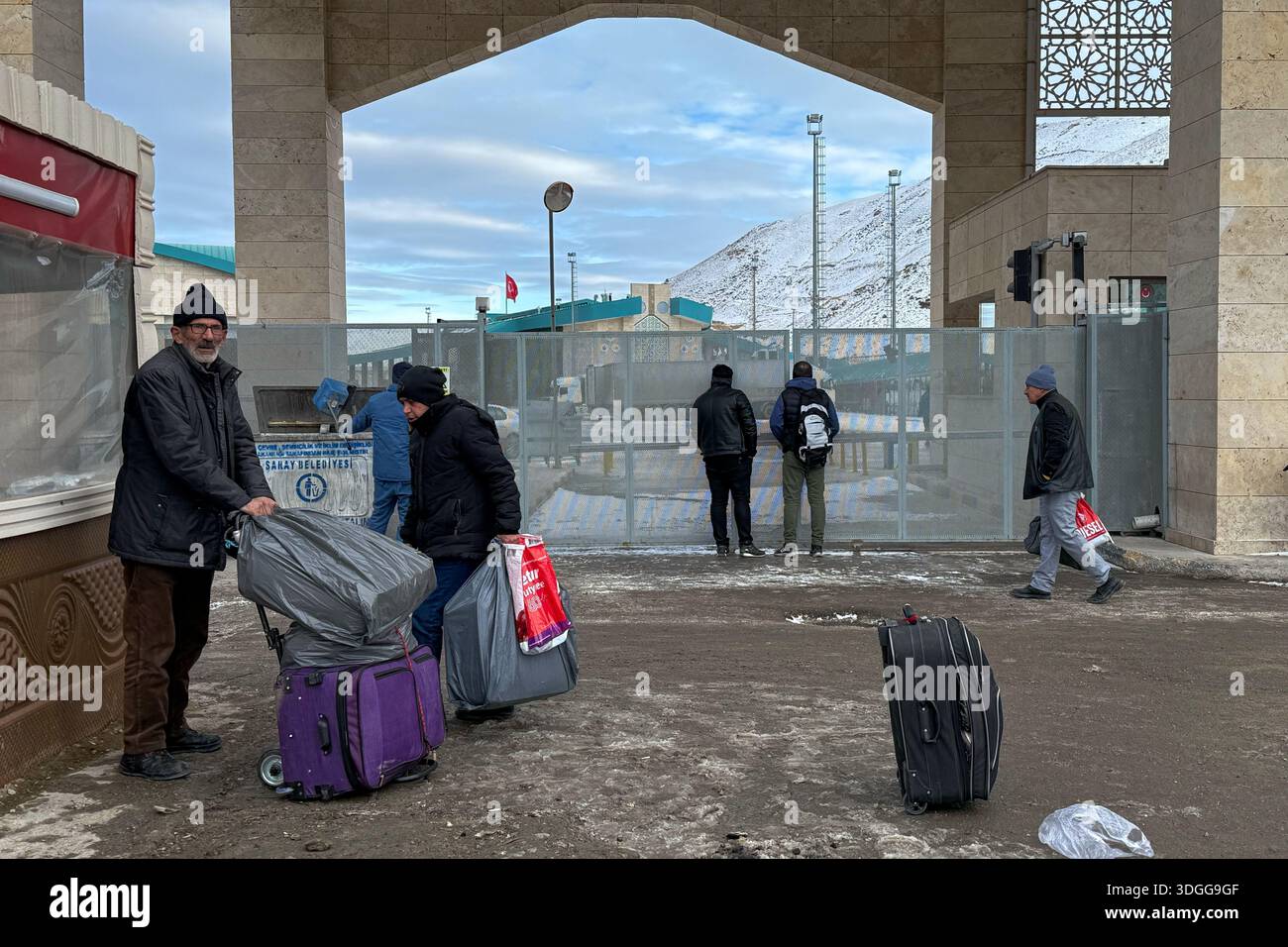People wait at Kapikoy border post between Turkey and Iran, in Kapikoy ...