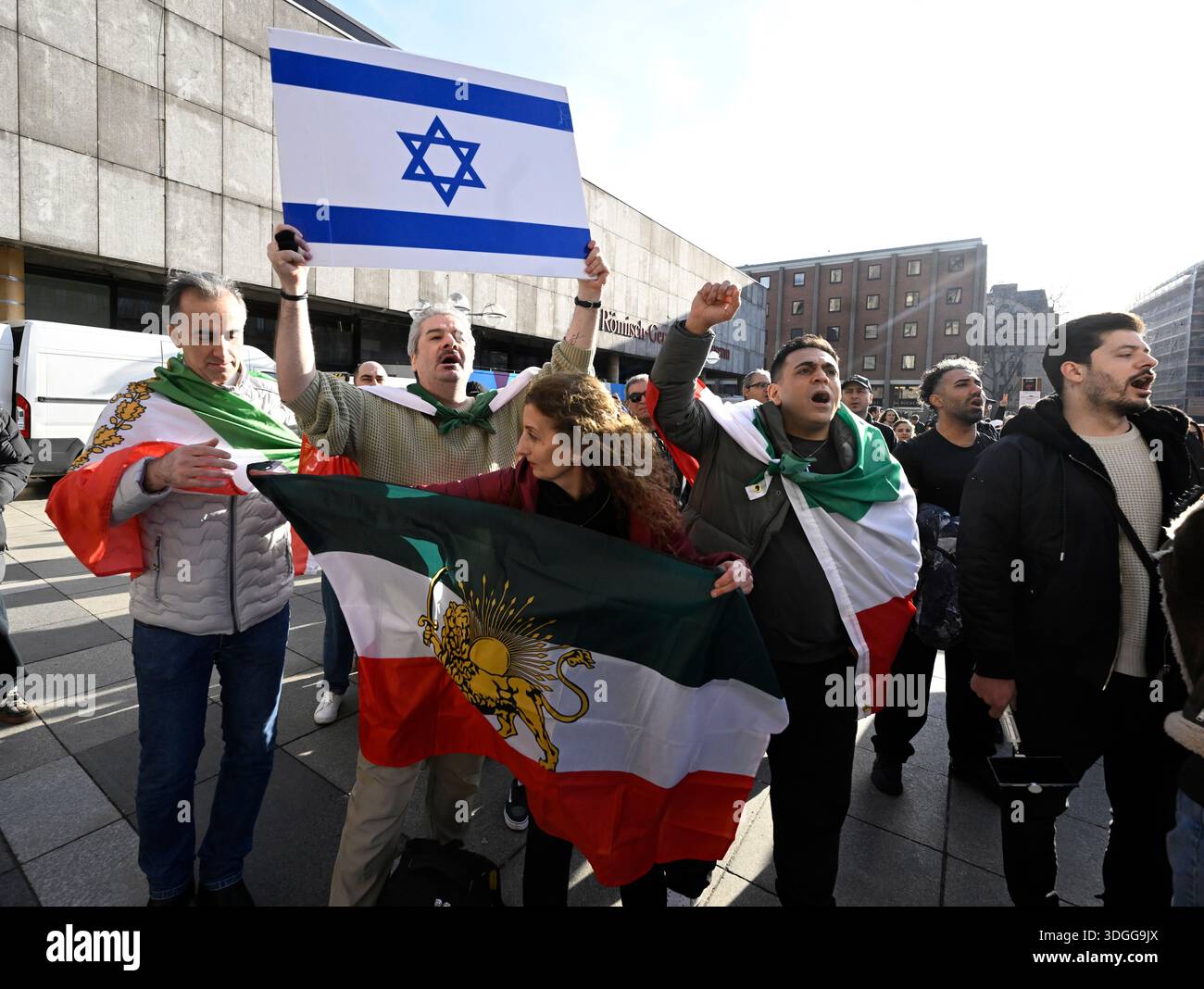 Cologne, Germany. 17th Jan, 2026. Participants hold signs and flags ...