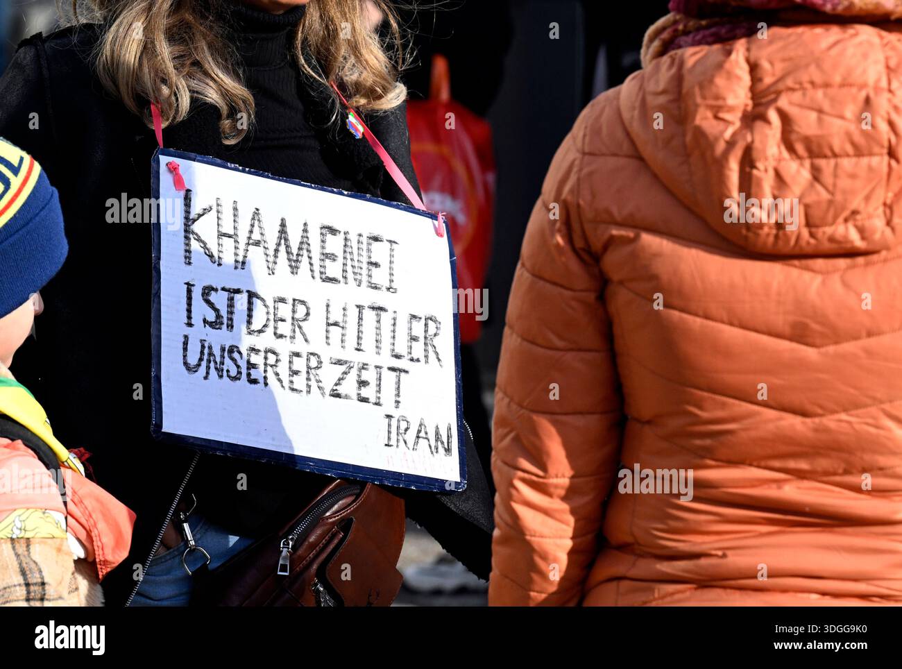 Cologne, Germany. 17th Jan, 2026. Participants hold signs and flags ...
