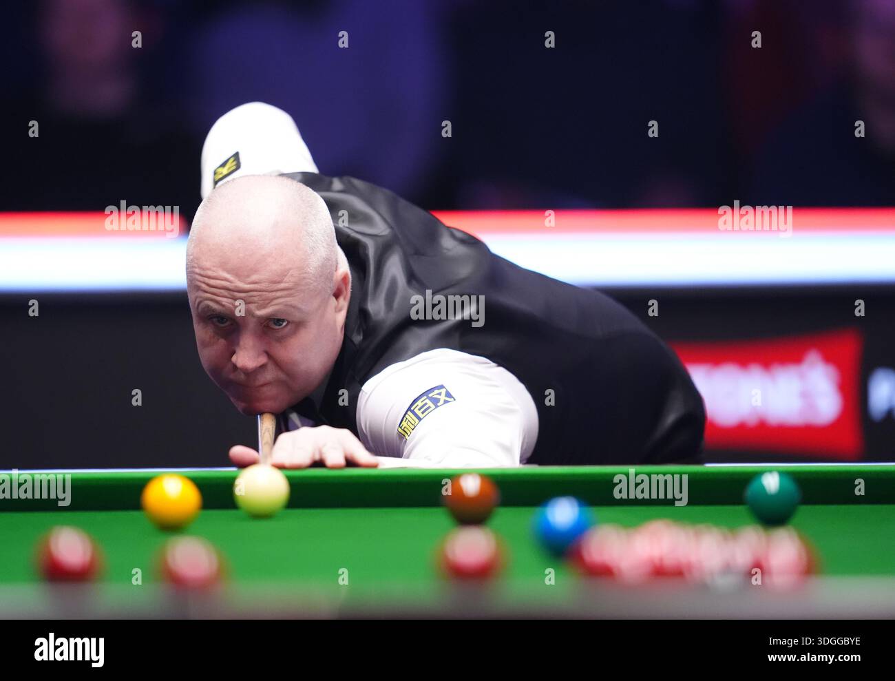 John Higgins in action against Judd Trump (not pictured) on day seven ...