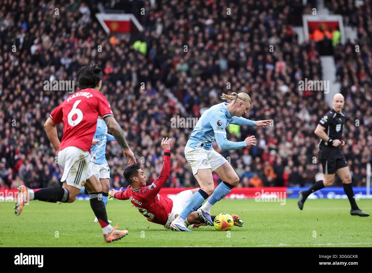 Casemiro of Manchester United slide tackles Erling Haaland of ...