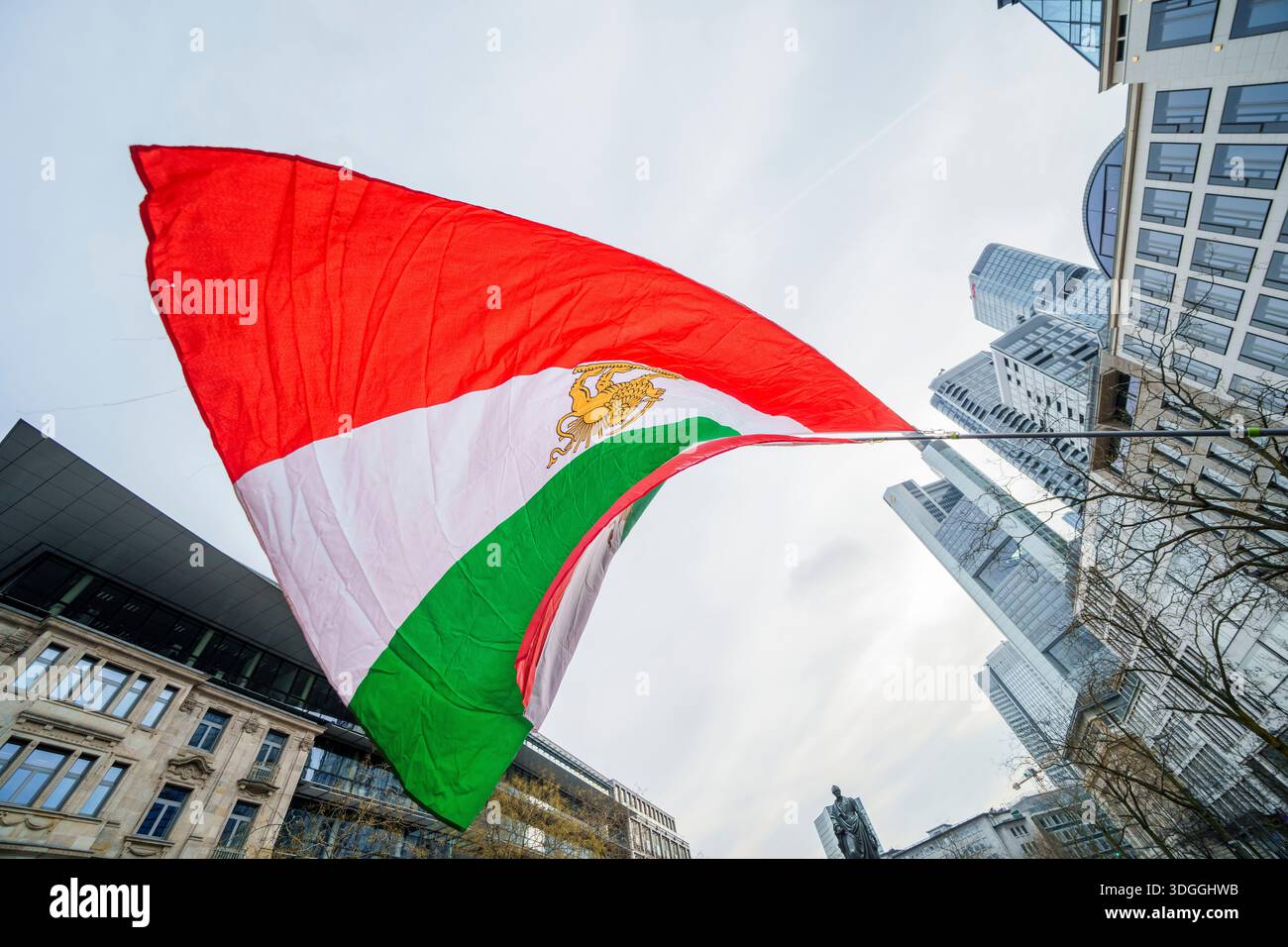 17 January 2026, Hesse, Frankfurt/Main: An Iranian flag is waved at a ...