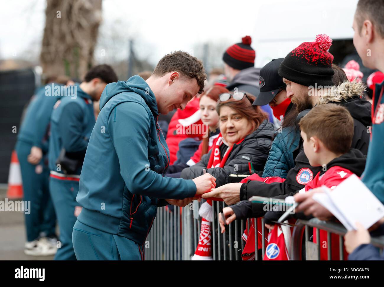 Wrexham's Nathan Broadhead signs autographs for fans as he arrives at ...
