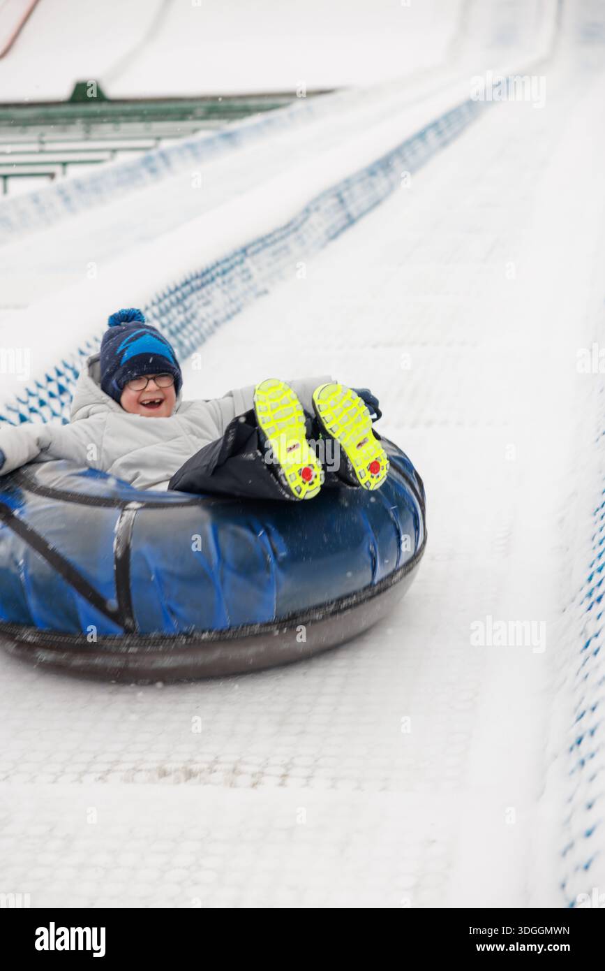 Child enjoying snow tubing hi-res stock photography and images - Alamy