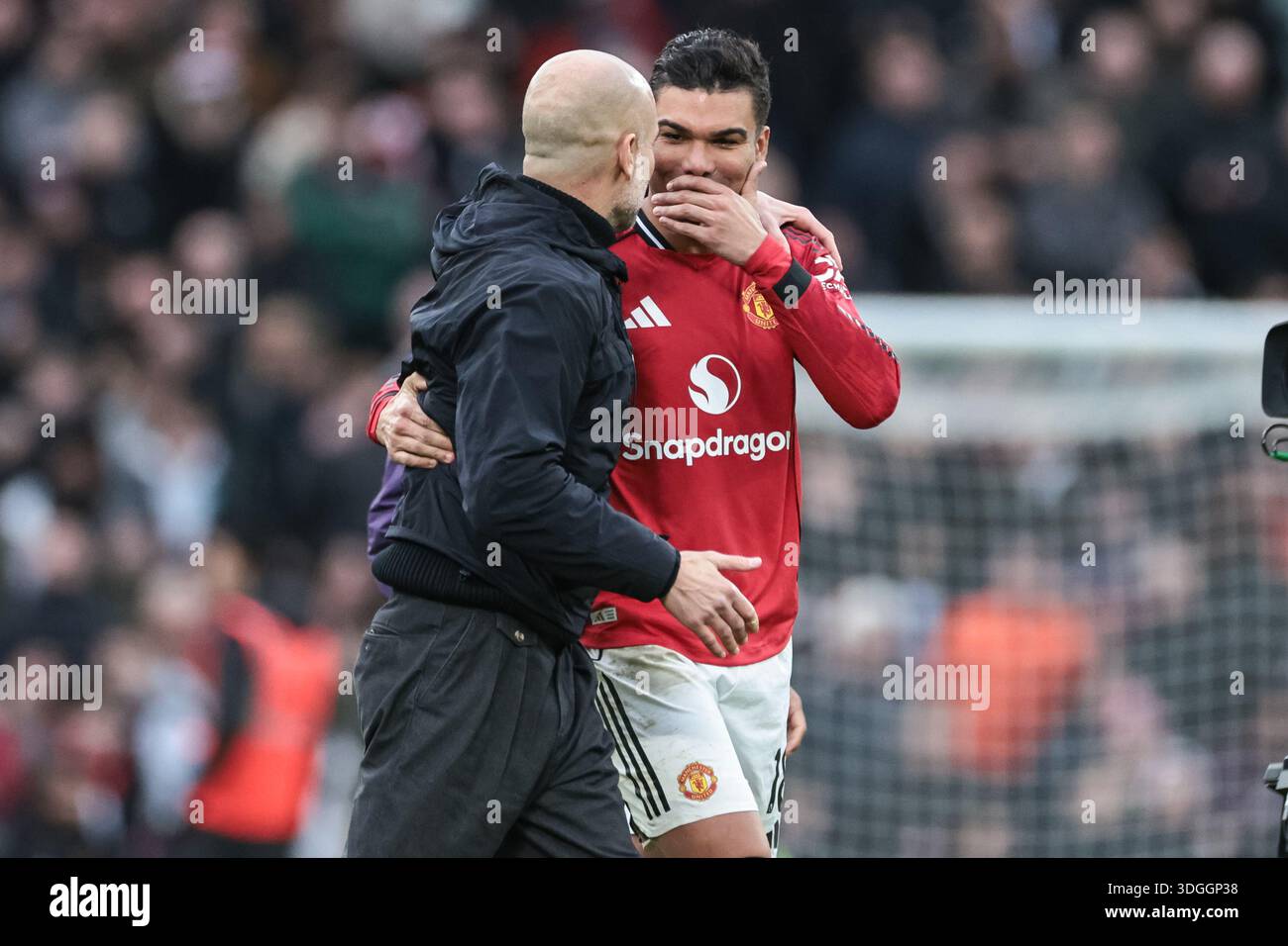 Pep Guardiola manager of Manchester City speaks with Casemiro of ...