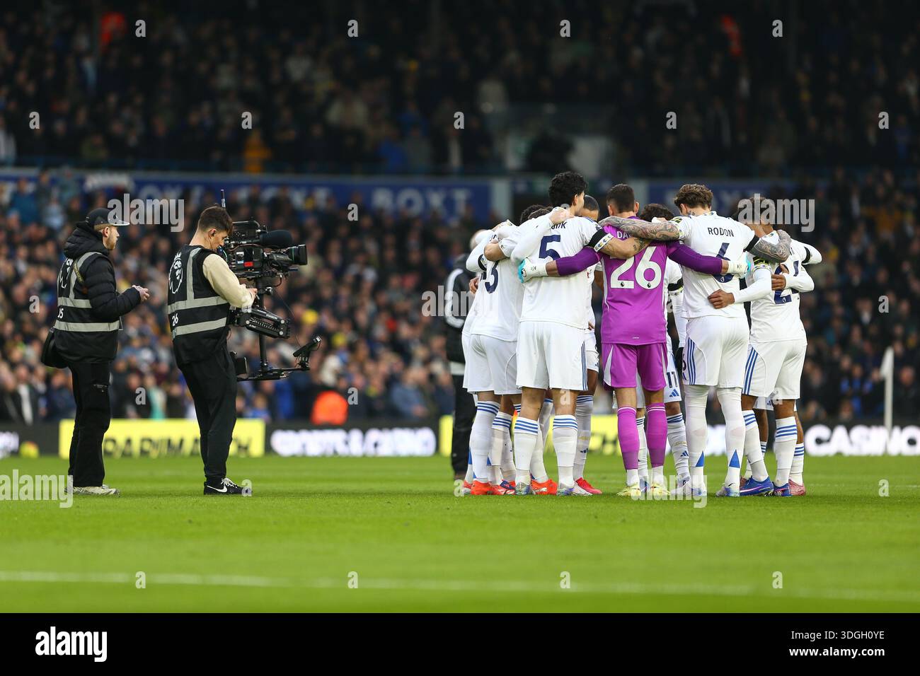The Leeds United players huddle during the Premier League match between ...