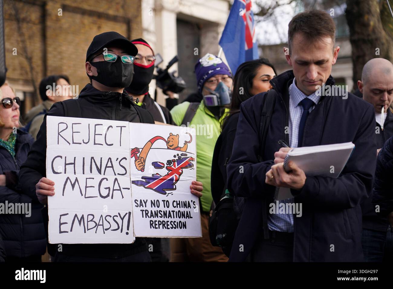Demonstrators hold placards and flags as they attend a protest against ...