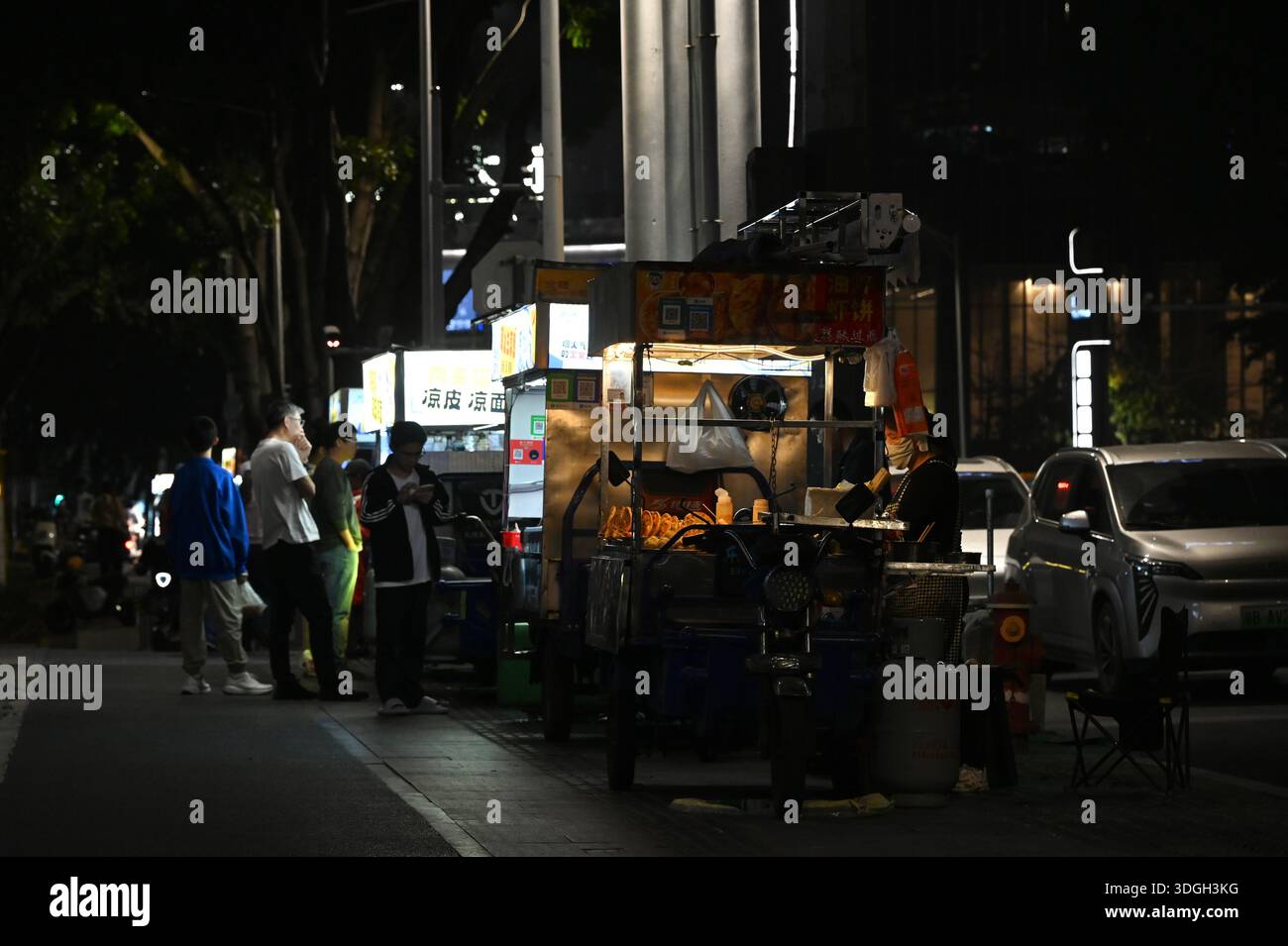 A general view showing the hawkers and the night market on the sidewalk ...