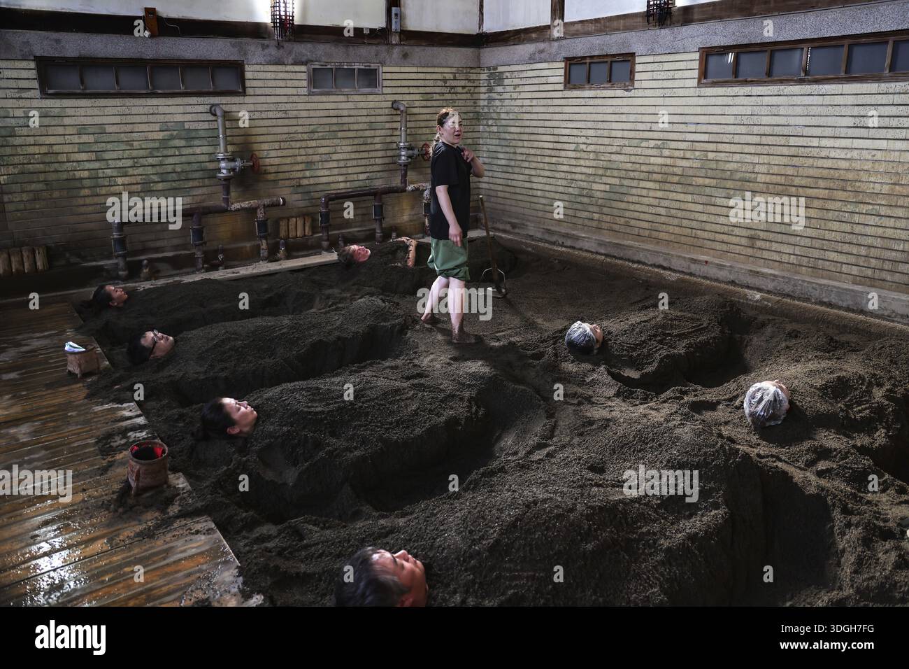 Visitors to Takegawara Onsen are deeply relaxed in sand baths, Beppu ...