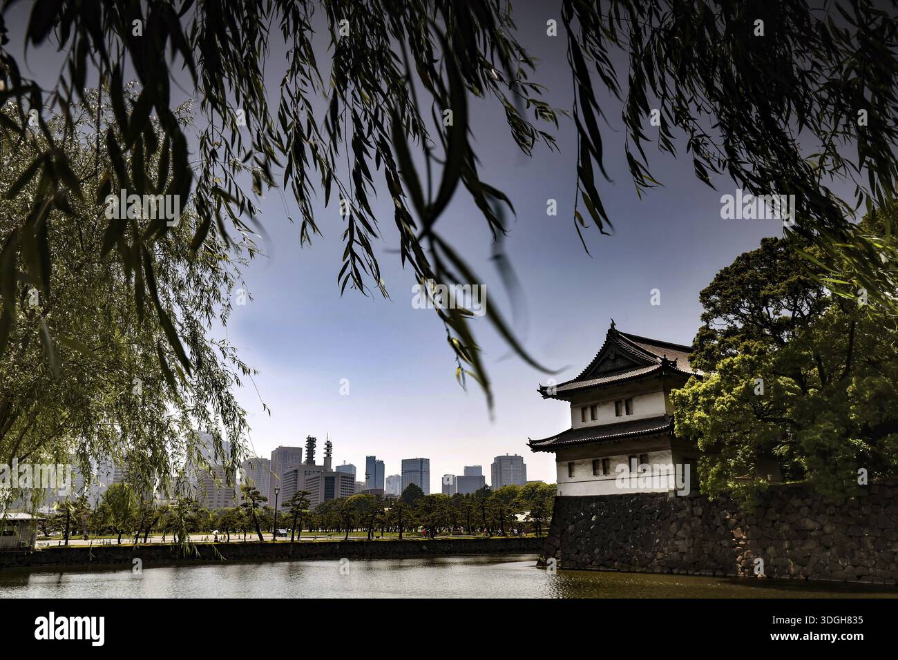 Imperial Palace wall with moat, modern buildings in the background ...