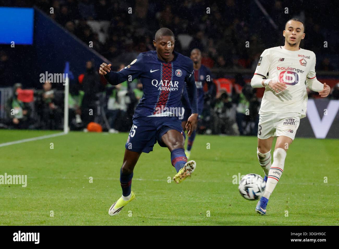 Paris, France. 16th Jan, 2026. PSG's Nuno Mendes battles Lille's Ethan ...