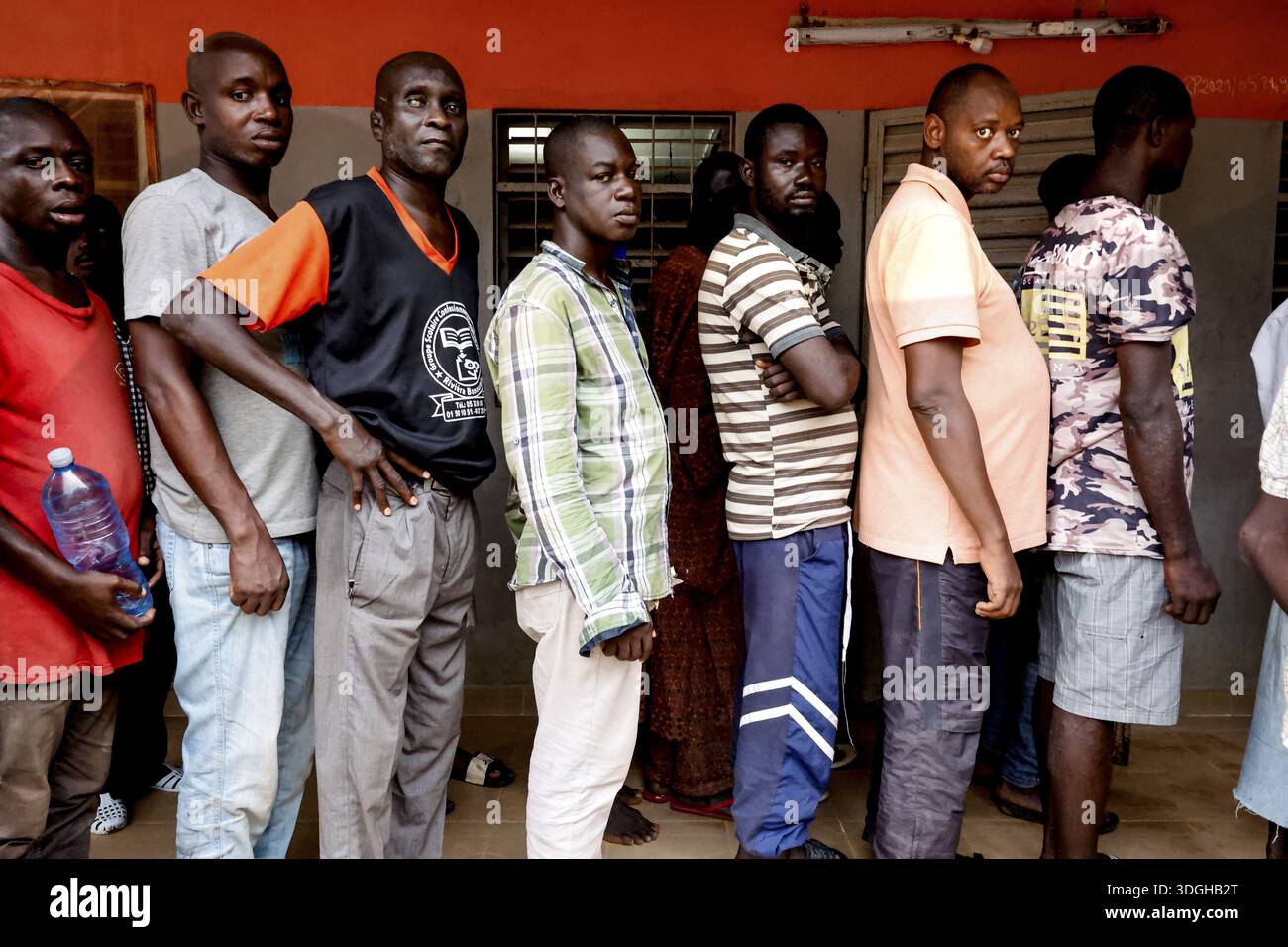 Men line up to dispense medication in a men's psychiatric ward, Bouake ...