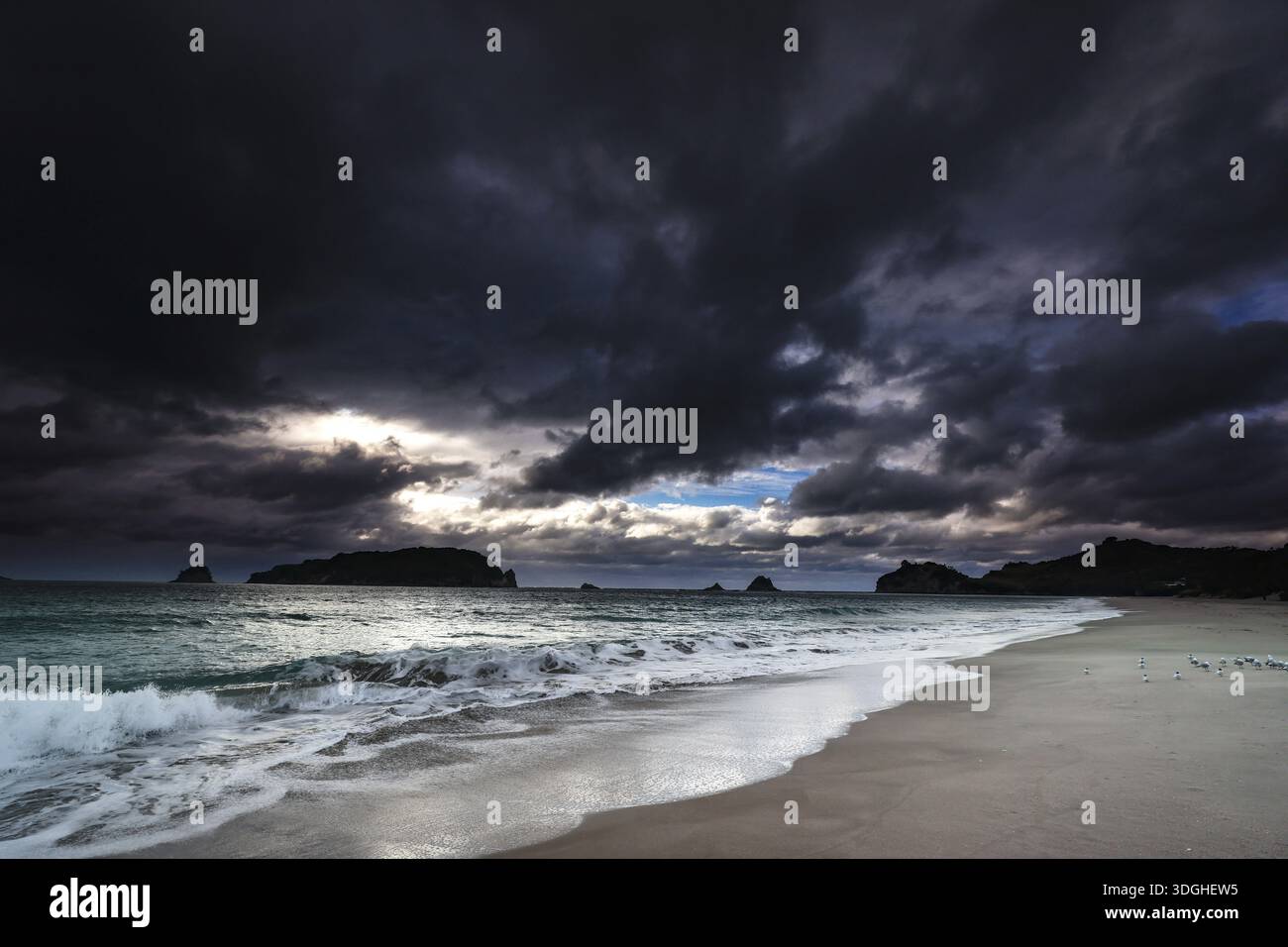 Dramatic sky over Hahei beach, dark clouds and rushing waves, Hahei ...