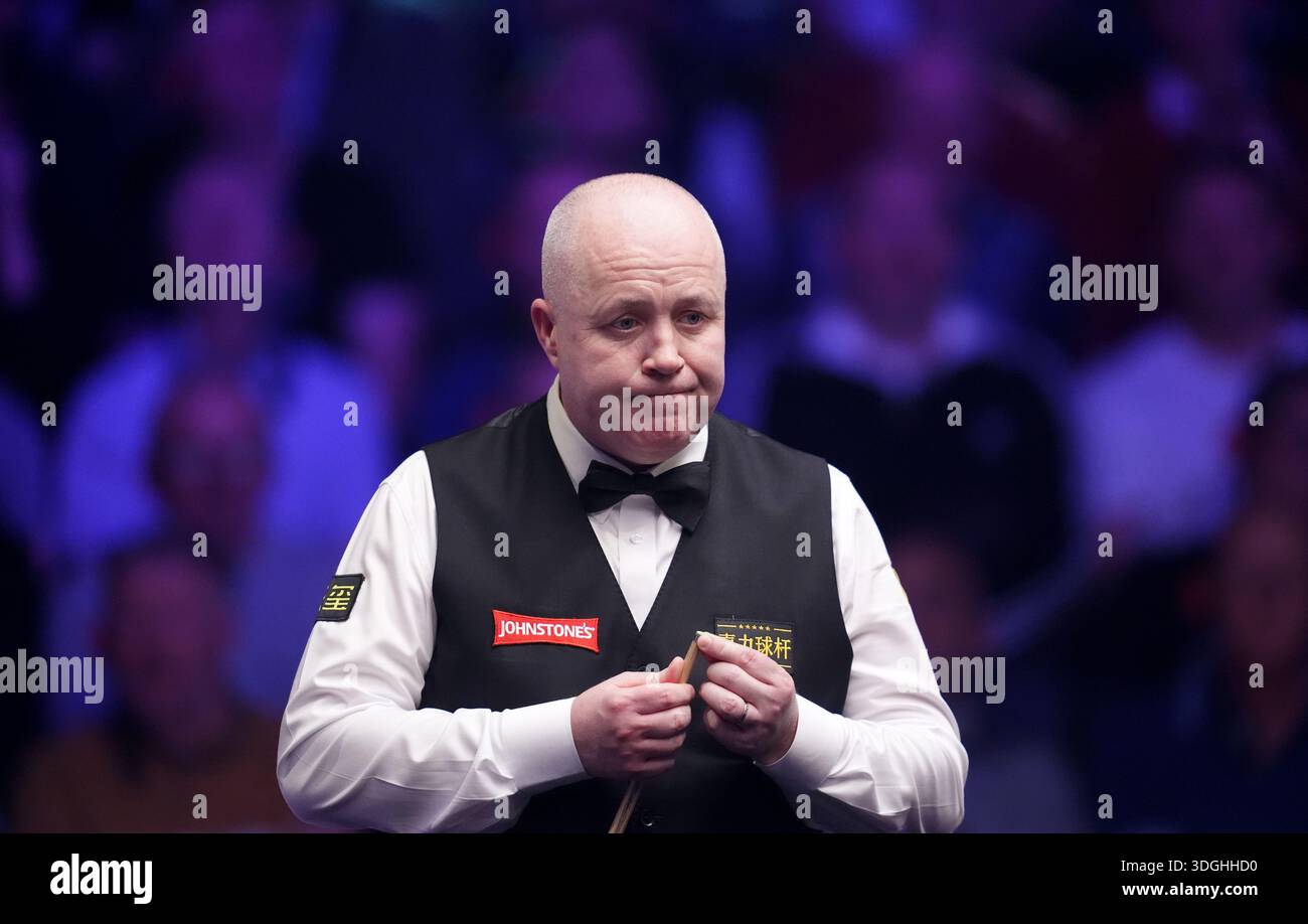 John Higgins in action against Judd Trump (not pictured) on day seven ...