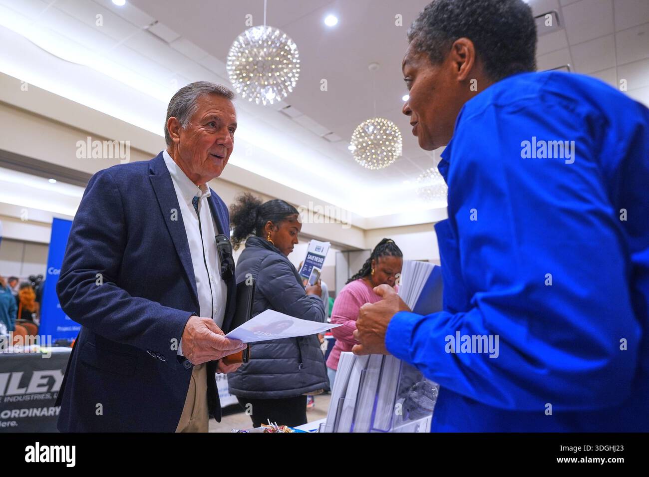 Job seeker James Baxter, left, listens to Carmen Joyner during a job ...