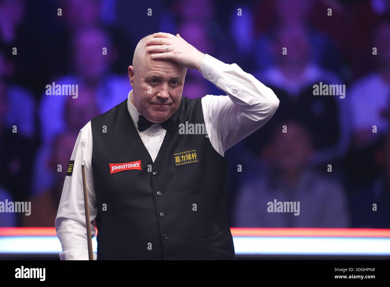 John Higgins in action against Judd Trump (not pictured) on day seven ...