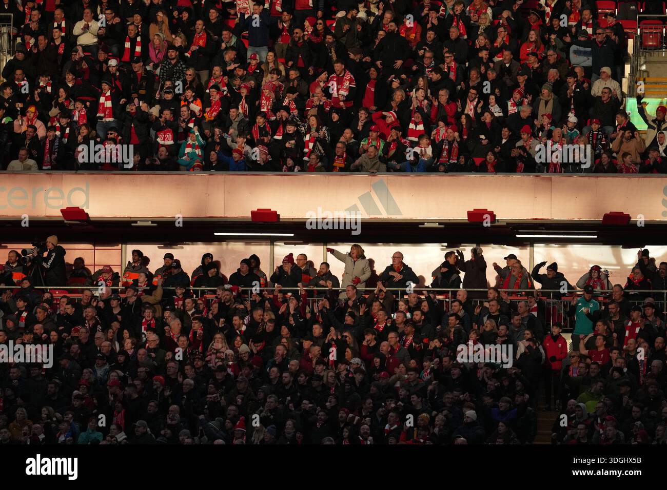 Fans watch the English Premier League soccer match between Liverpool ...