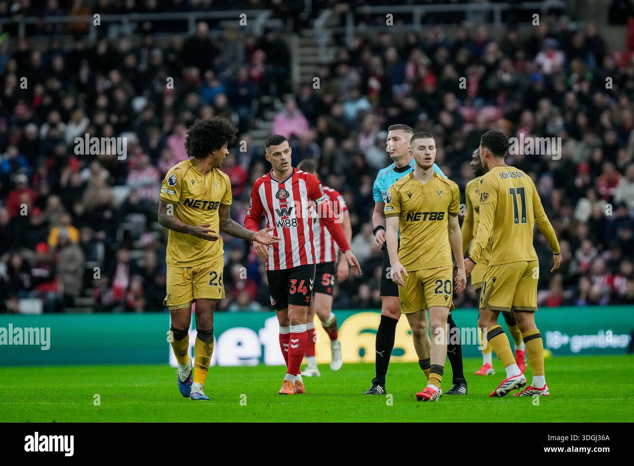 Referee Rob Jones speaks with Chris Richards of Crystal Palace after ...